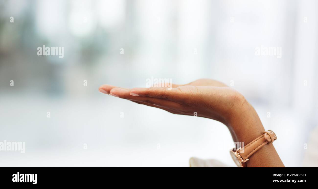 A woman hand open showing mockup space in the room of a modern building ...