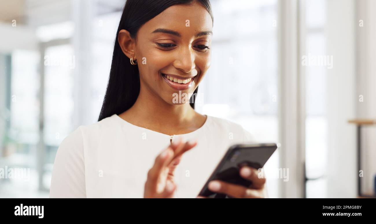 Happy Indian woman on her phone, social media or online search looking ...