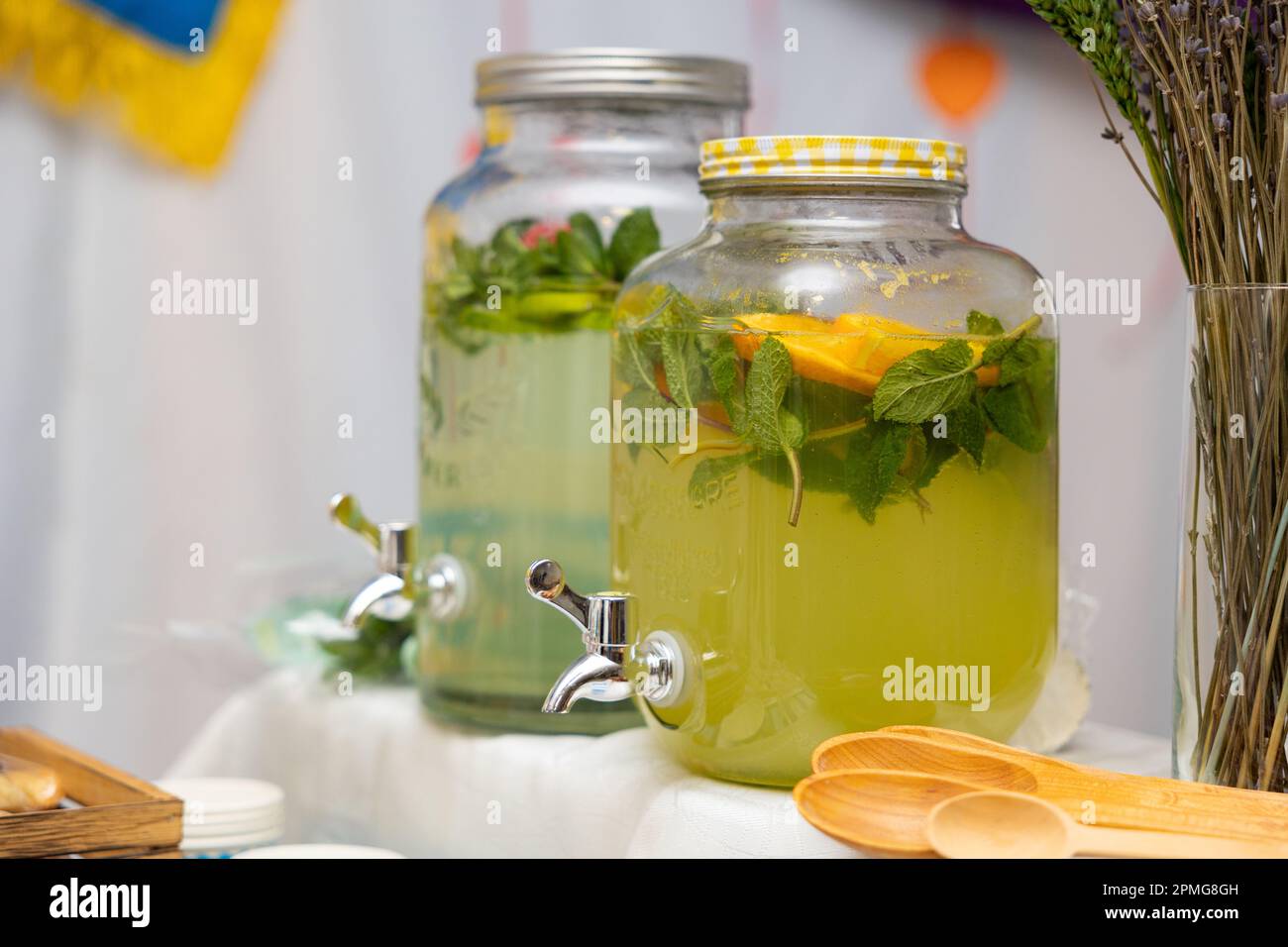 Lemonade dispenser close up with fruits: grapefruit, orange, lemon ...