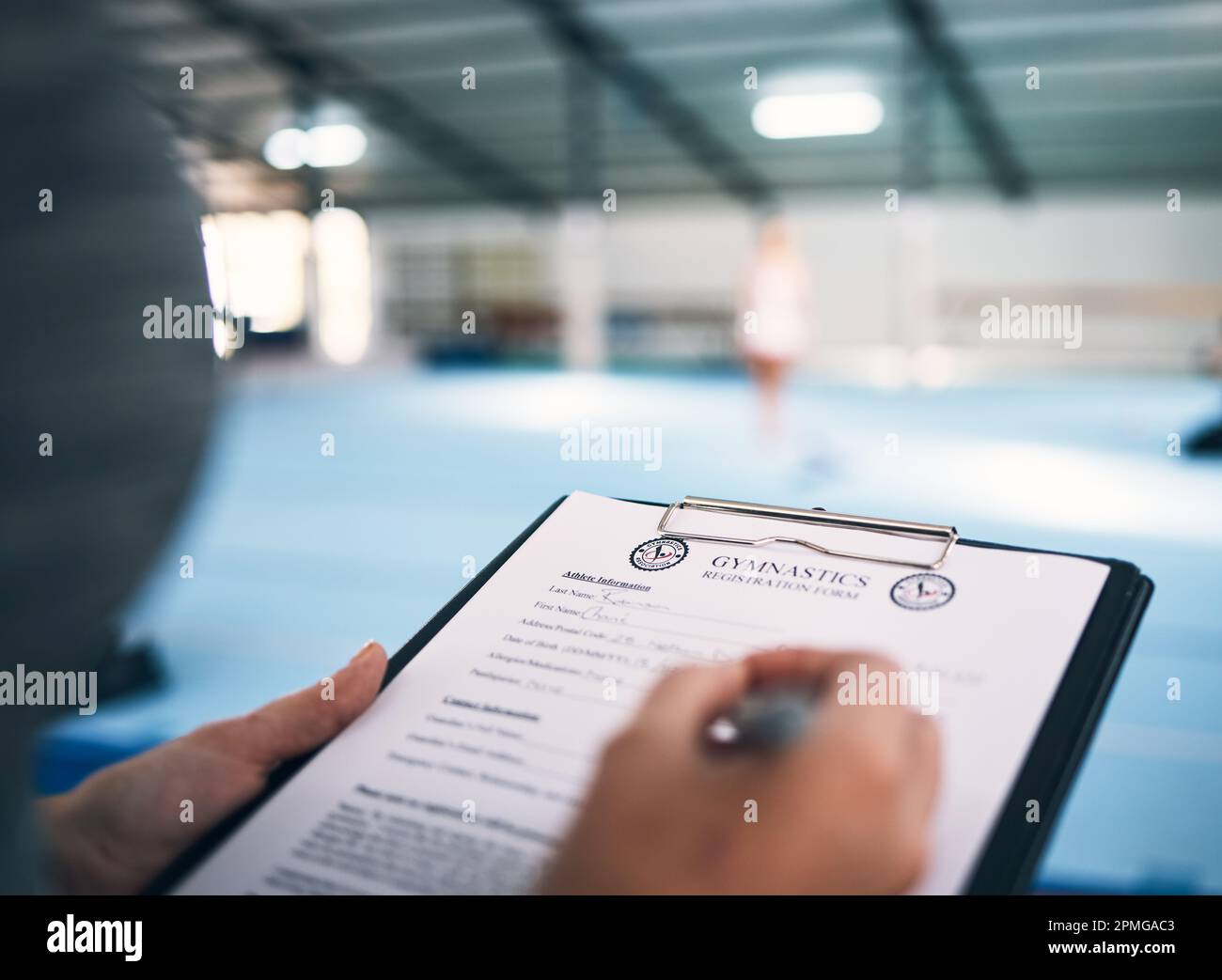 Hand, documents and sign up in a gym with a coach watching a ...