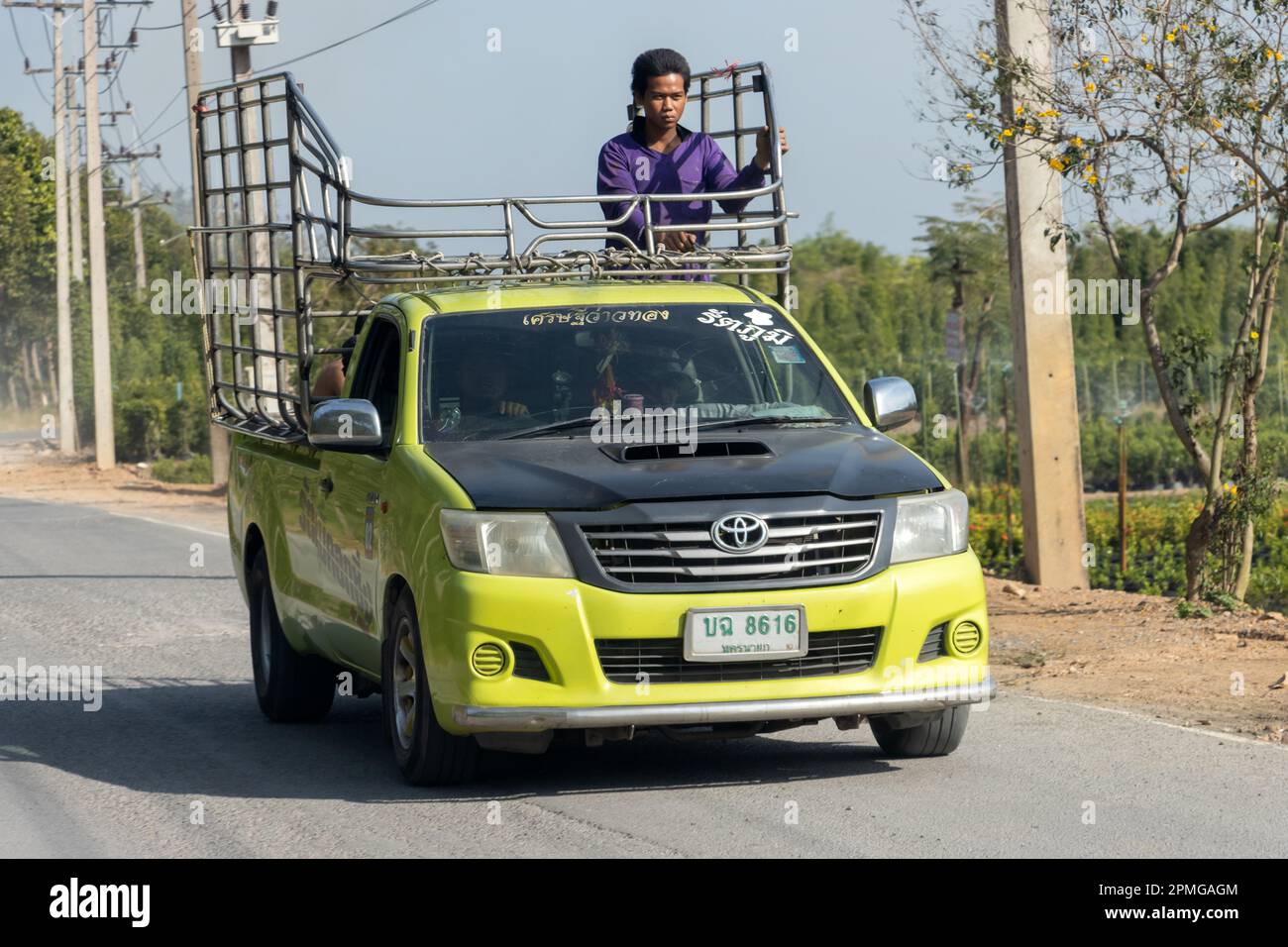 THAILAND, JAN 21 2023, A young man rides on the cargo bed of a pick-up ...