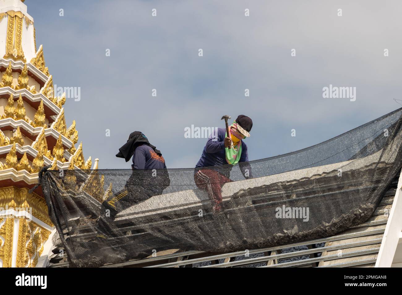 Men build a new roof at a Buddhist temple - Wat Pho Thong, Bangkok ...