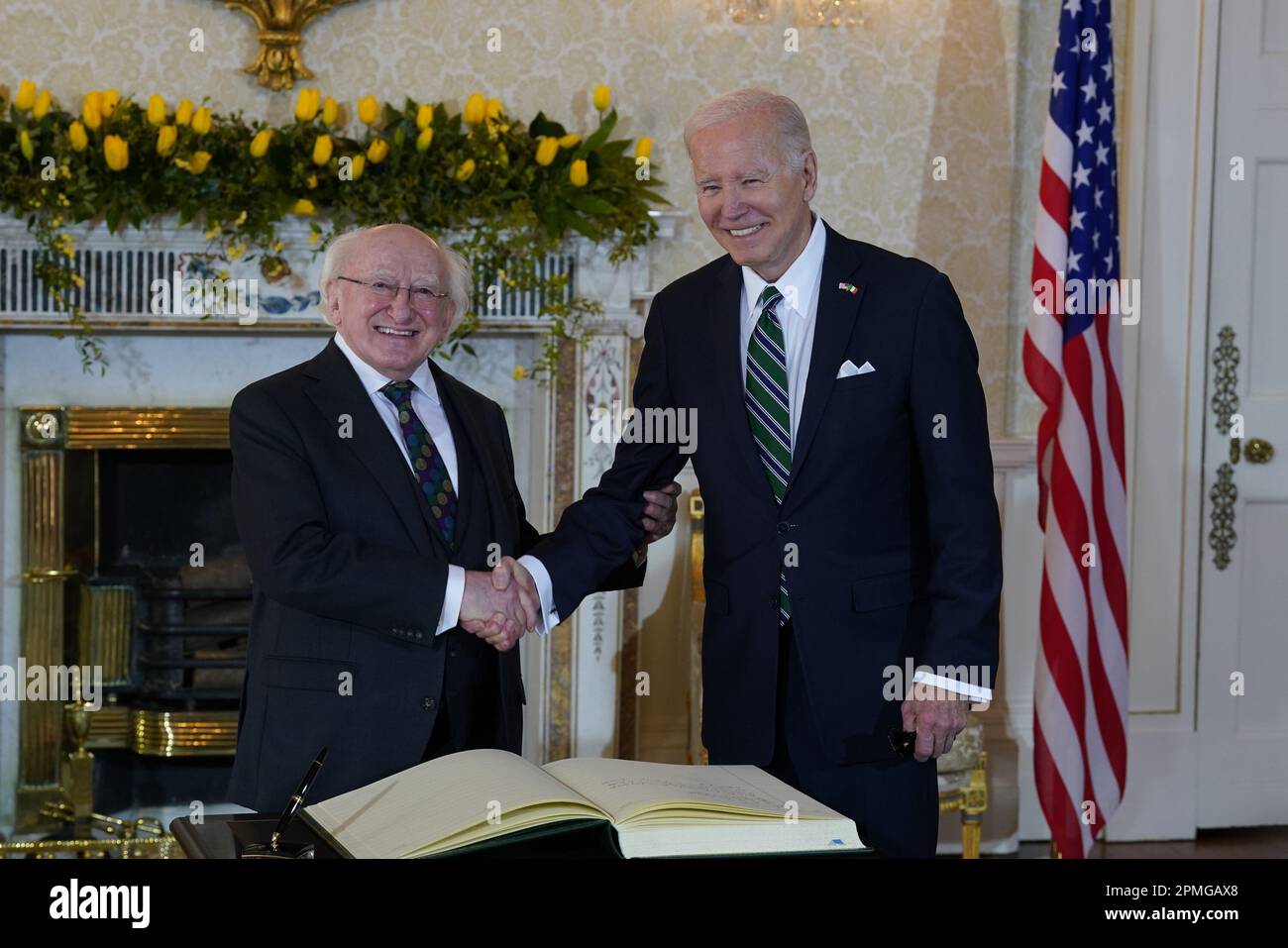 US President Joe Biden (right) shakes hands with Irish President ...