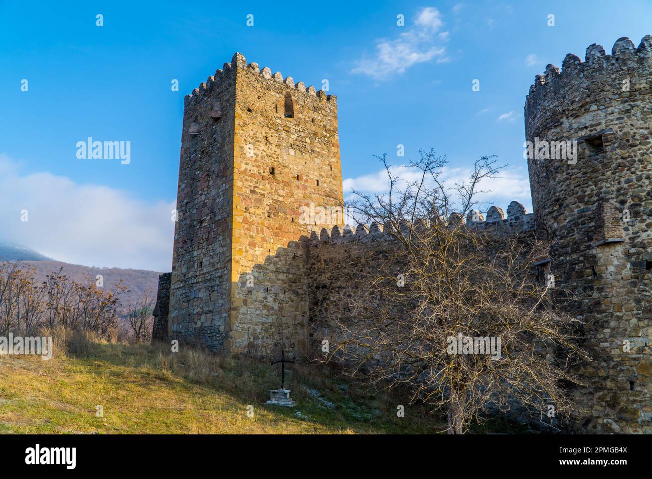 The historic 13th-century Ananuri Fortress under a bright blue sky in ...