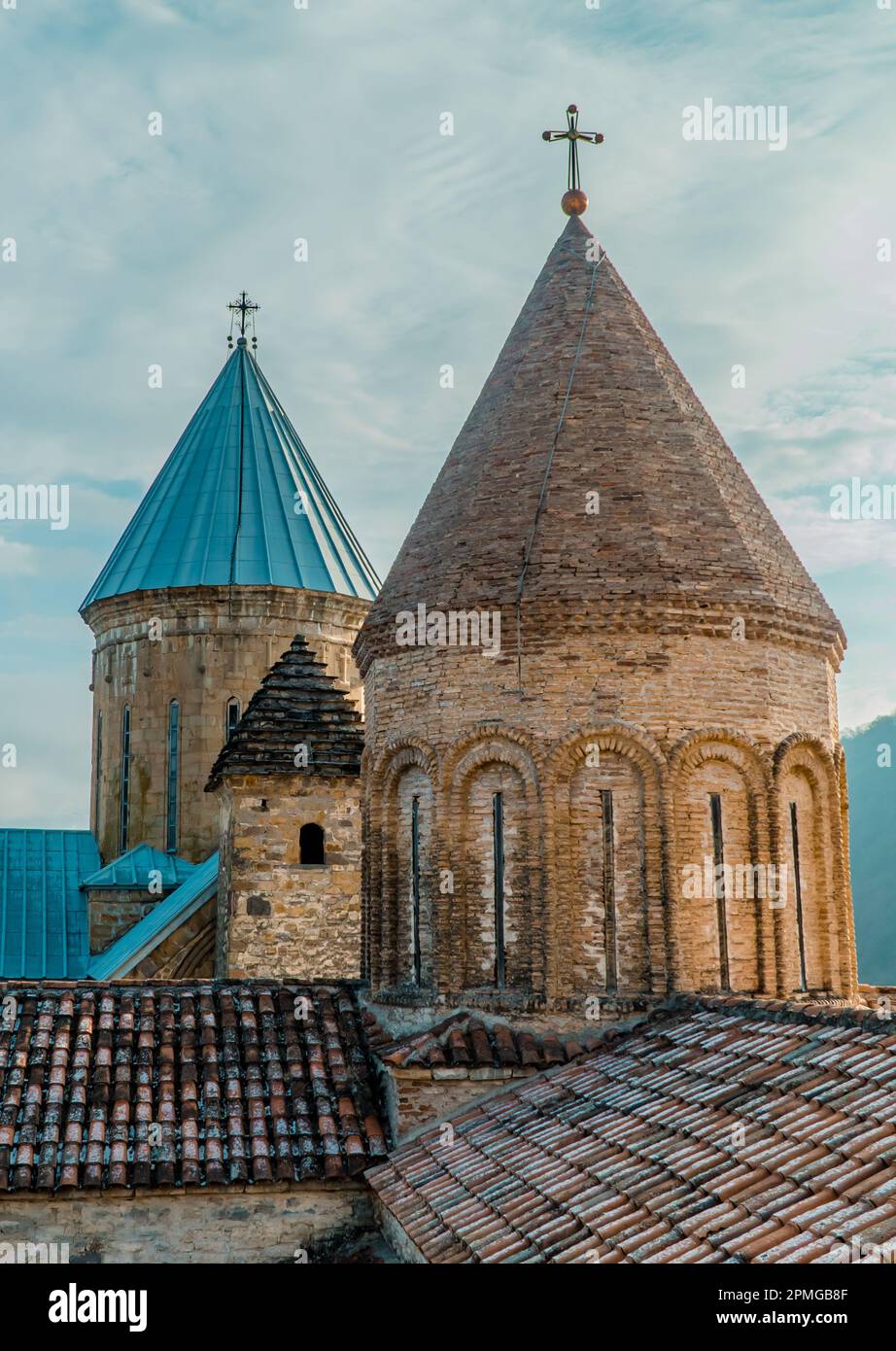 The historic 13th-century Ananuri Fortress under a bright blue sky in ...