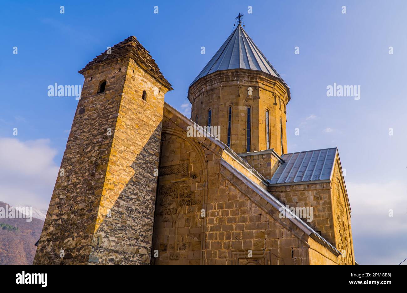 The historic 13th-century Ananuri Fortress under a bright blue sky in ...