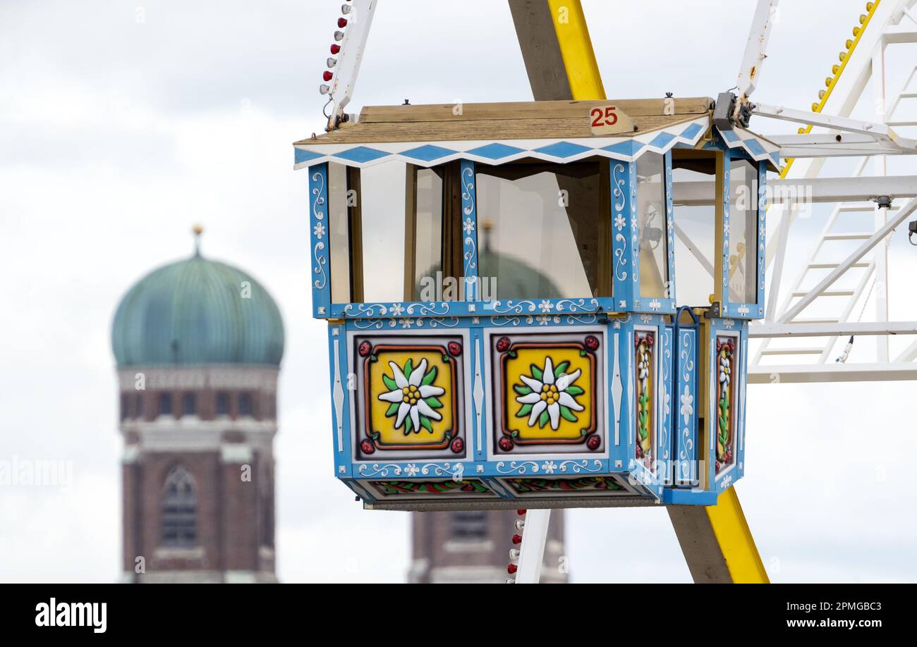 Munich, Germany. 13th Apr, 2023. A Ferris wheel and the towers of the ...