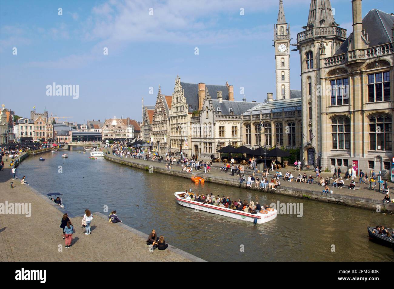 Tourist and boats at Graslei on the Leie river with historical ...