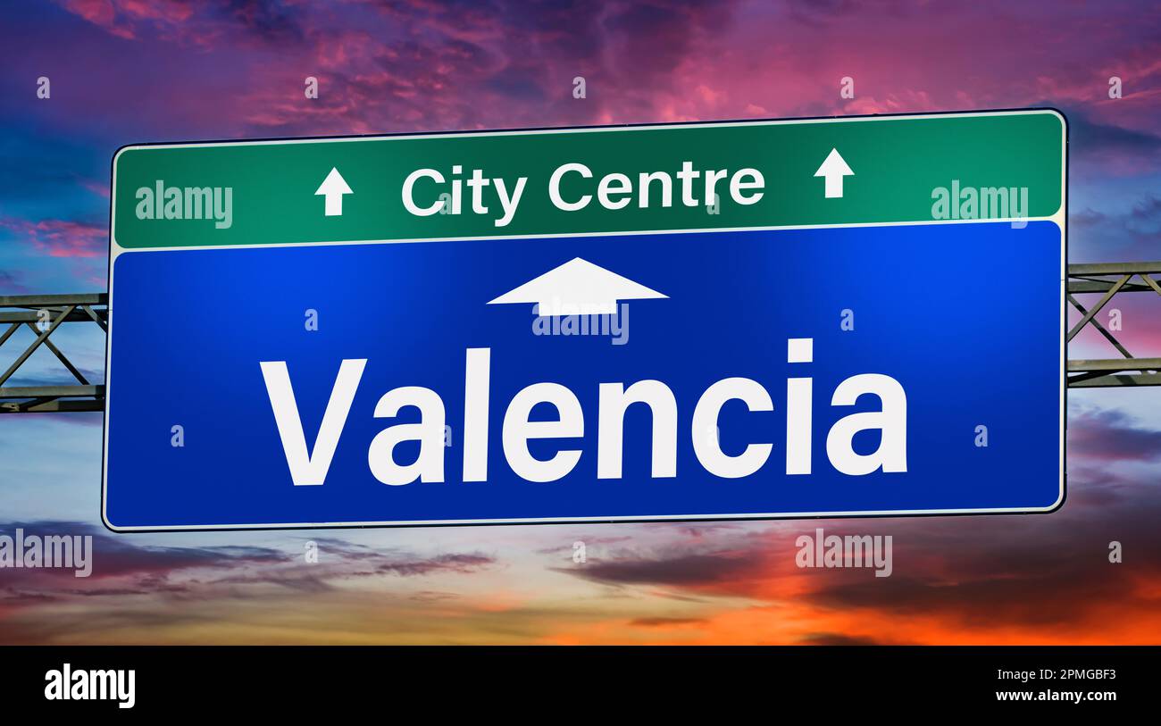 Road sign indicating direction to the city of Valencia Stock Photo - Alamy