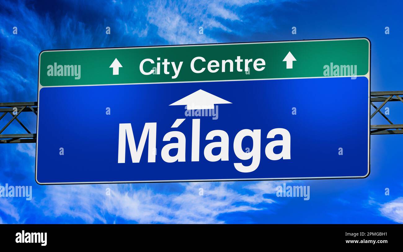 Road sign indicating direction to the city of Malaga Stock Photo - Alamy