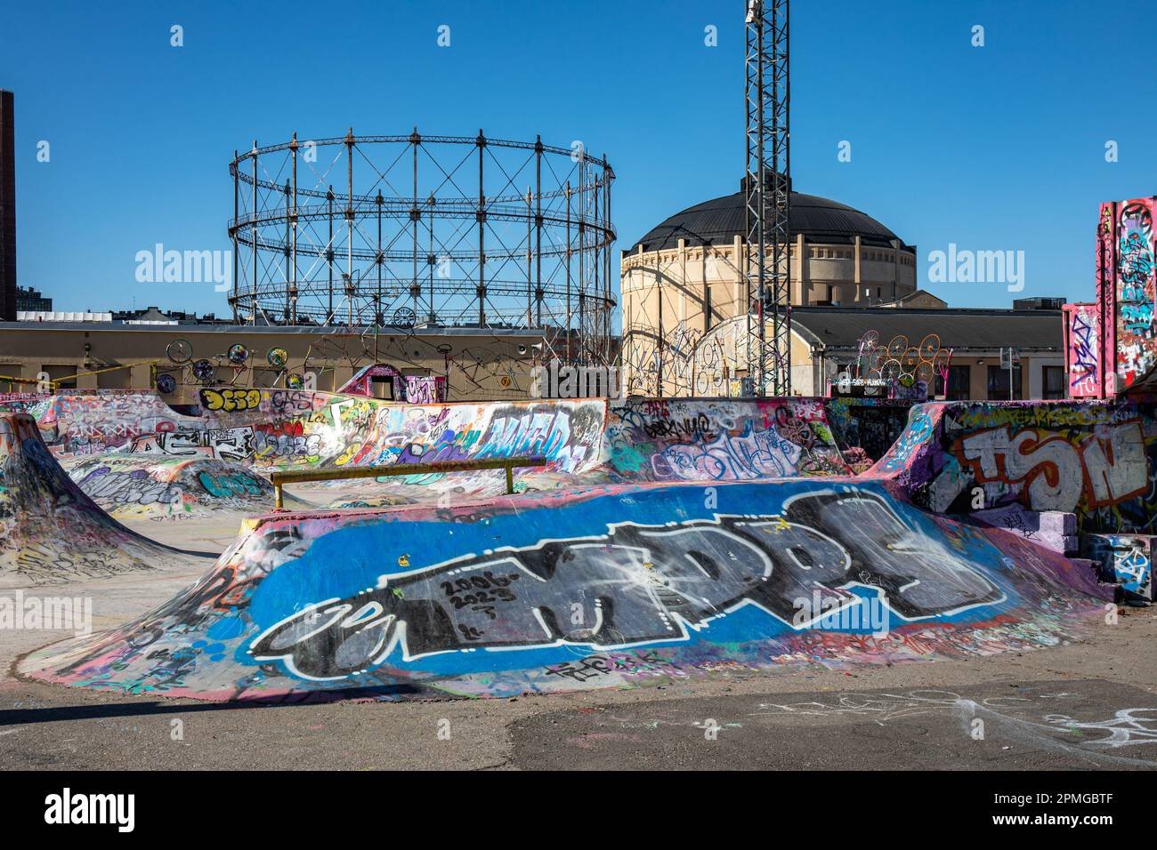 Graffiti covered Suvilahti DIY Skatepark against a backdrop of old gas ...
