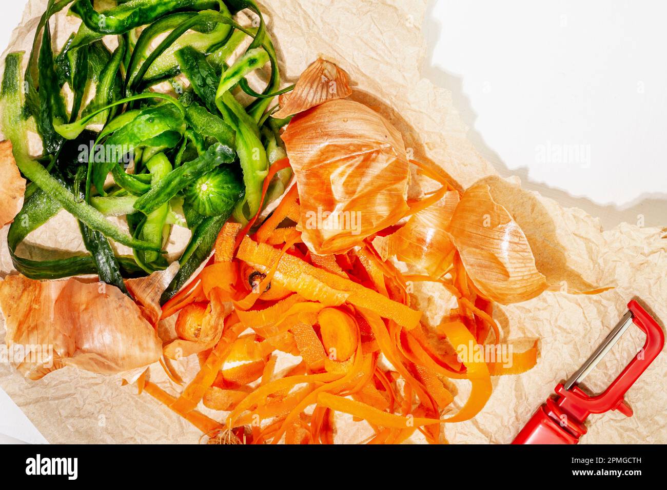 Vegetable scraps ready for composting. Vegetable peelings on wrapping ...