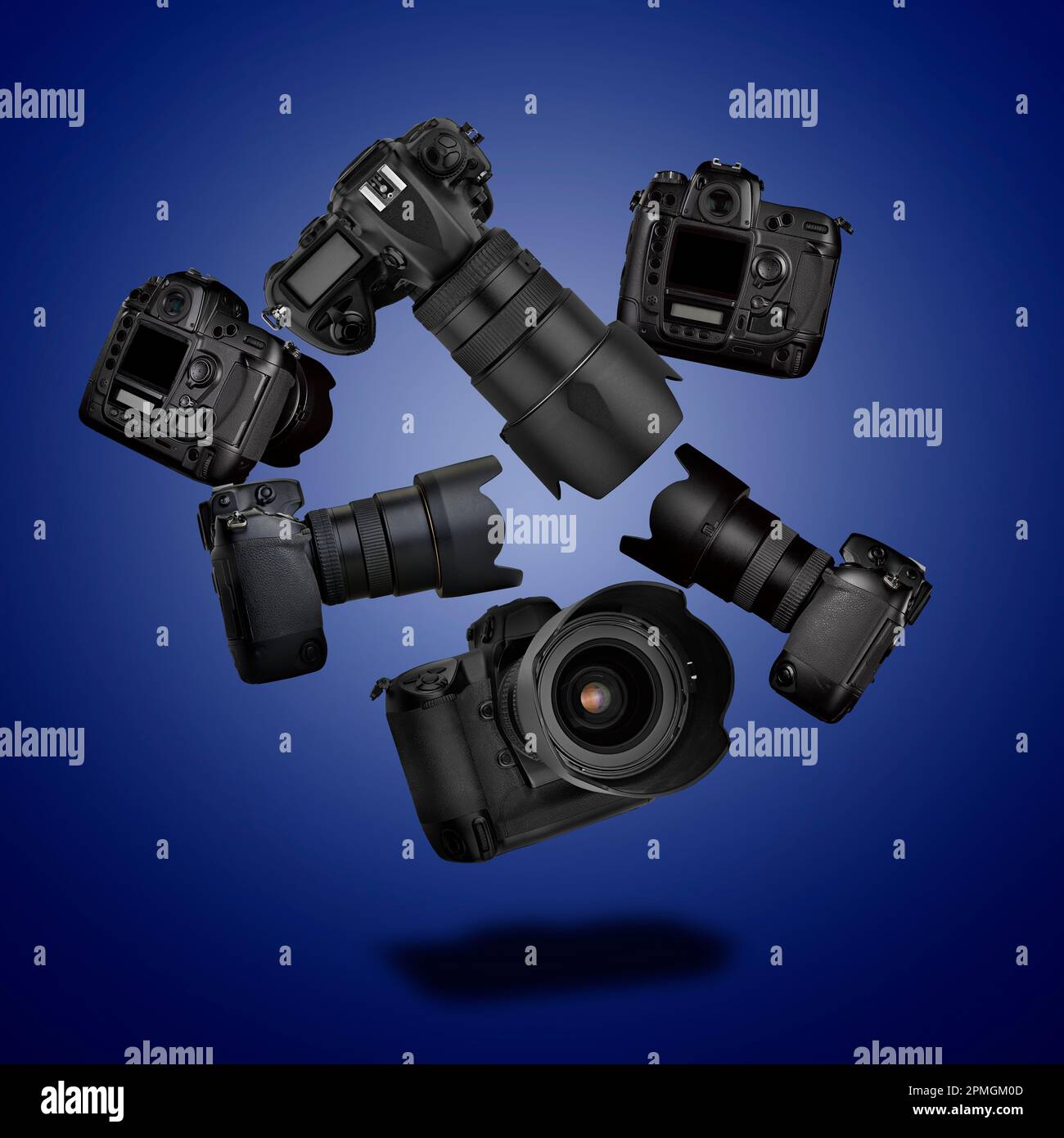 Floating professional digital Lens Reflex camera on blue radial ...