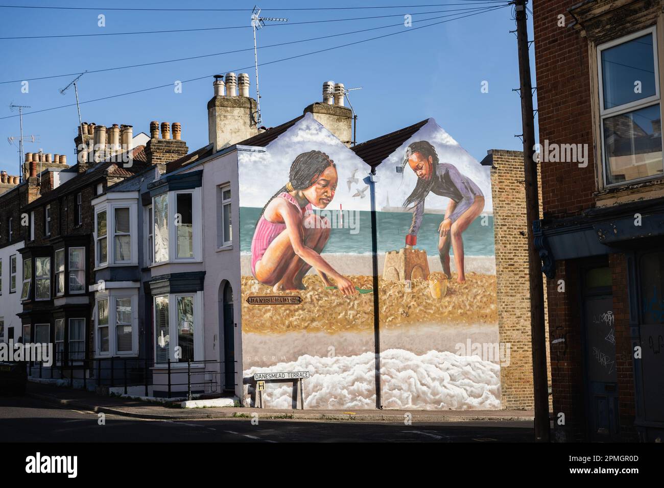 Street Art in Margate, Kent in the East of England, shows two young ...