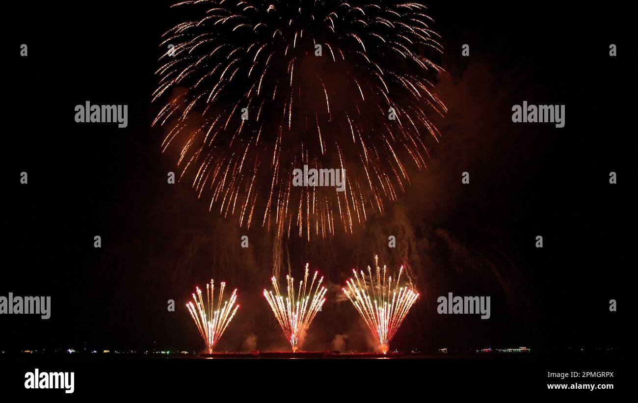 Abstract colored real firework background with big shining glowing fireworks show with bokeh ...
