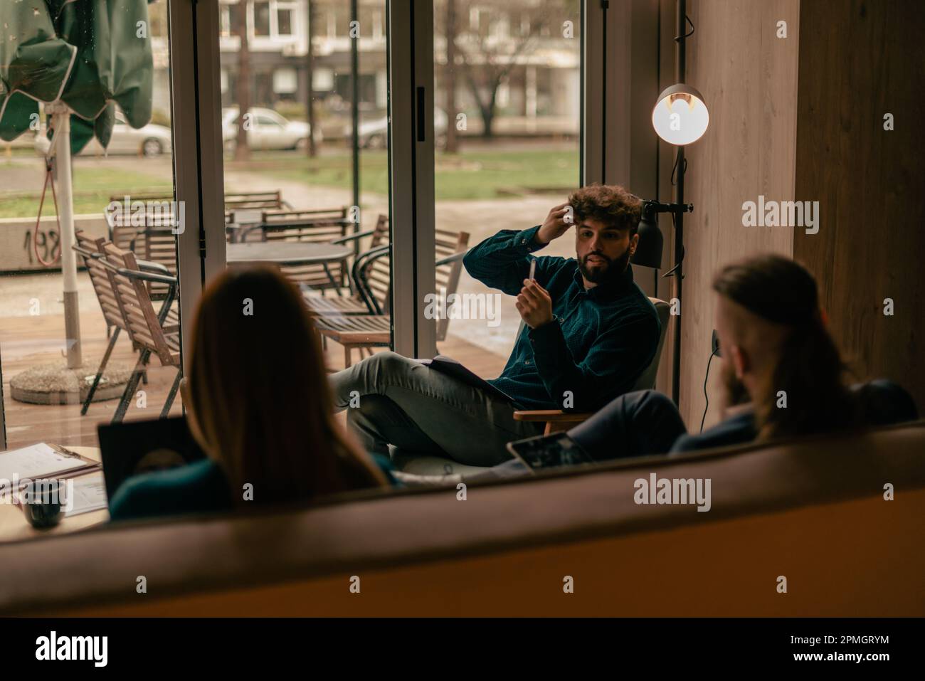 Three business coworkers working remotely at the coffee bar. Handsome ...