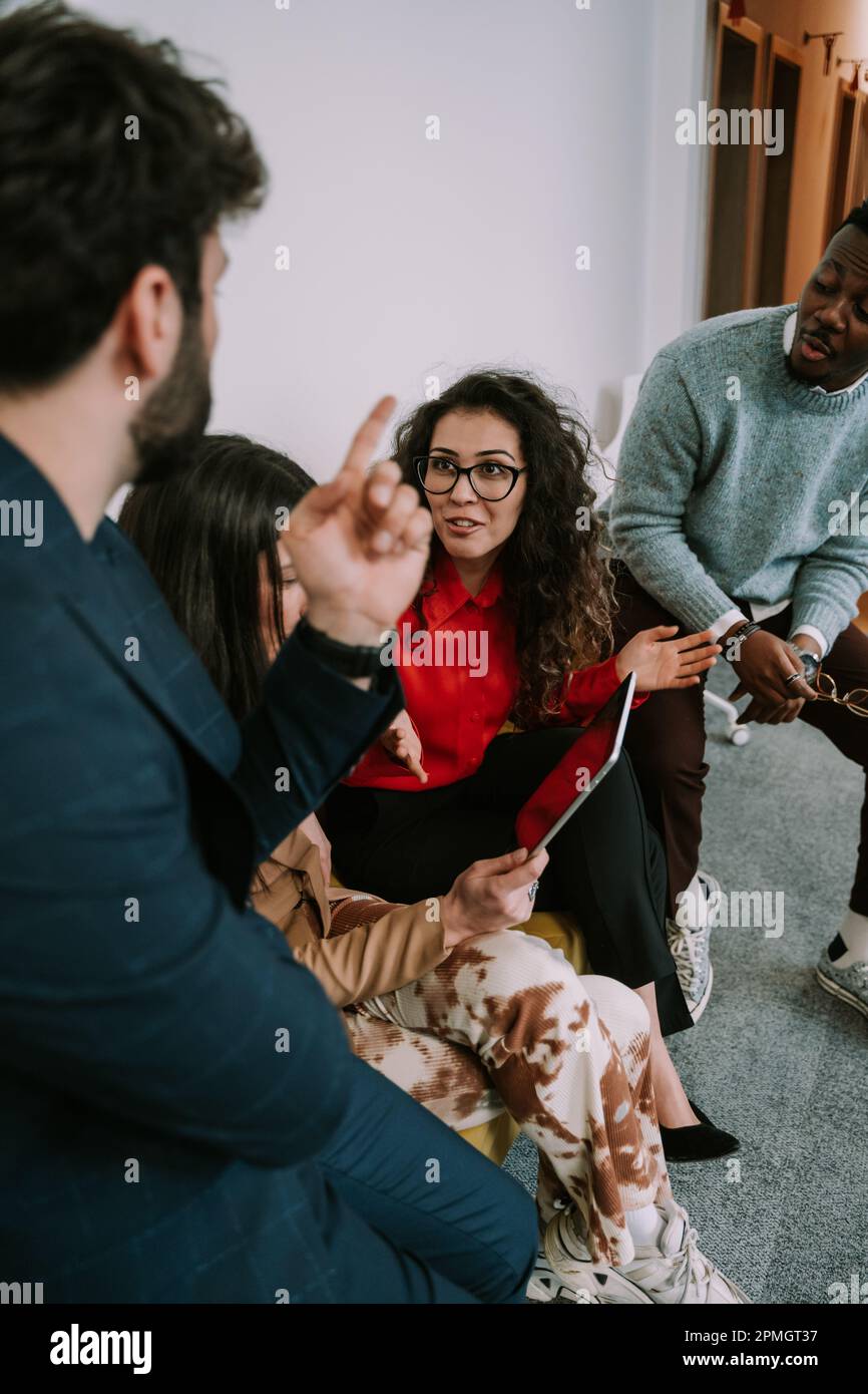 Multiracial colleagues talking at the same time after they went in deep ...
