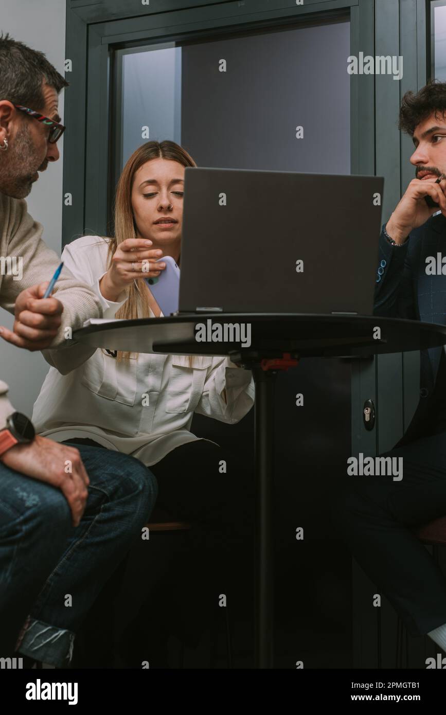 Two male inter-generational colleagues discussing business while their ...