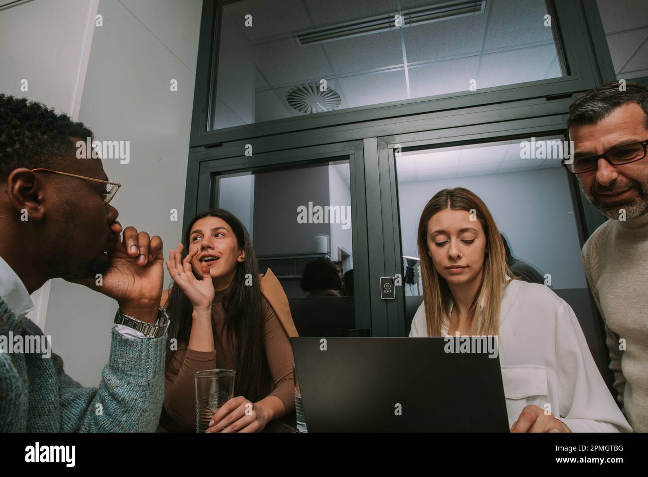 Inter-generational diverse group of people brainstorming while working ...