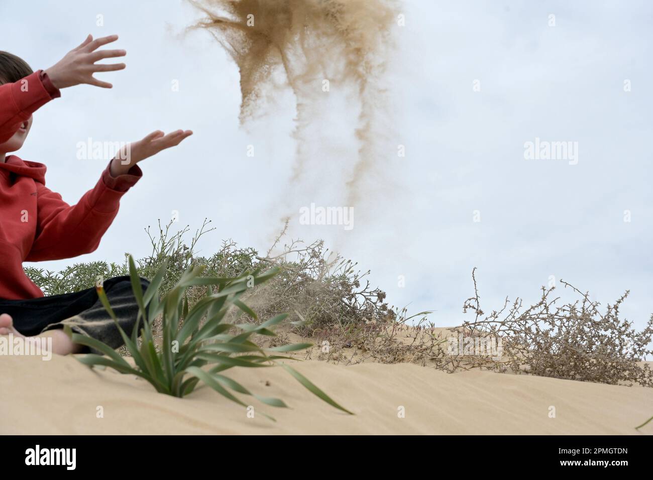 boy throwing sand Stock Photo - Alamy