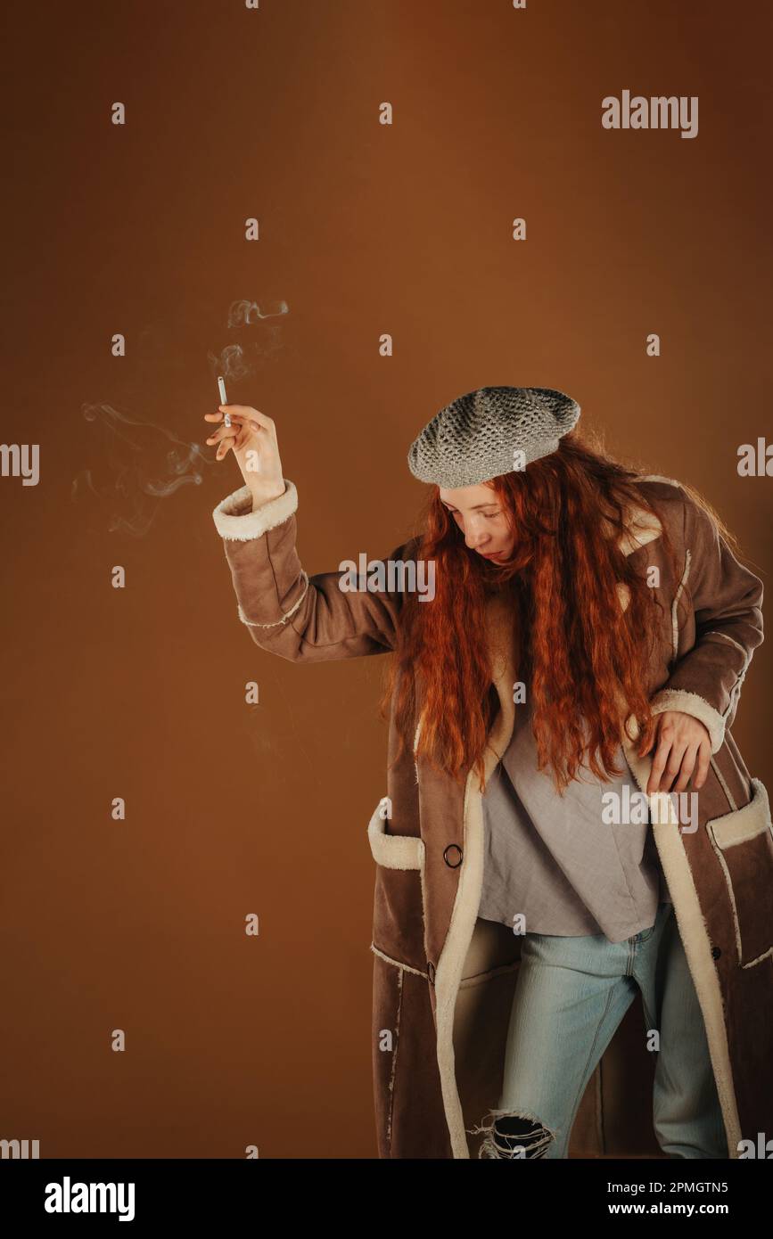 Beautiful ginger girl smoking cigarette and dancing at the studio Stock ...
