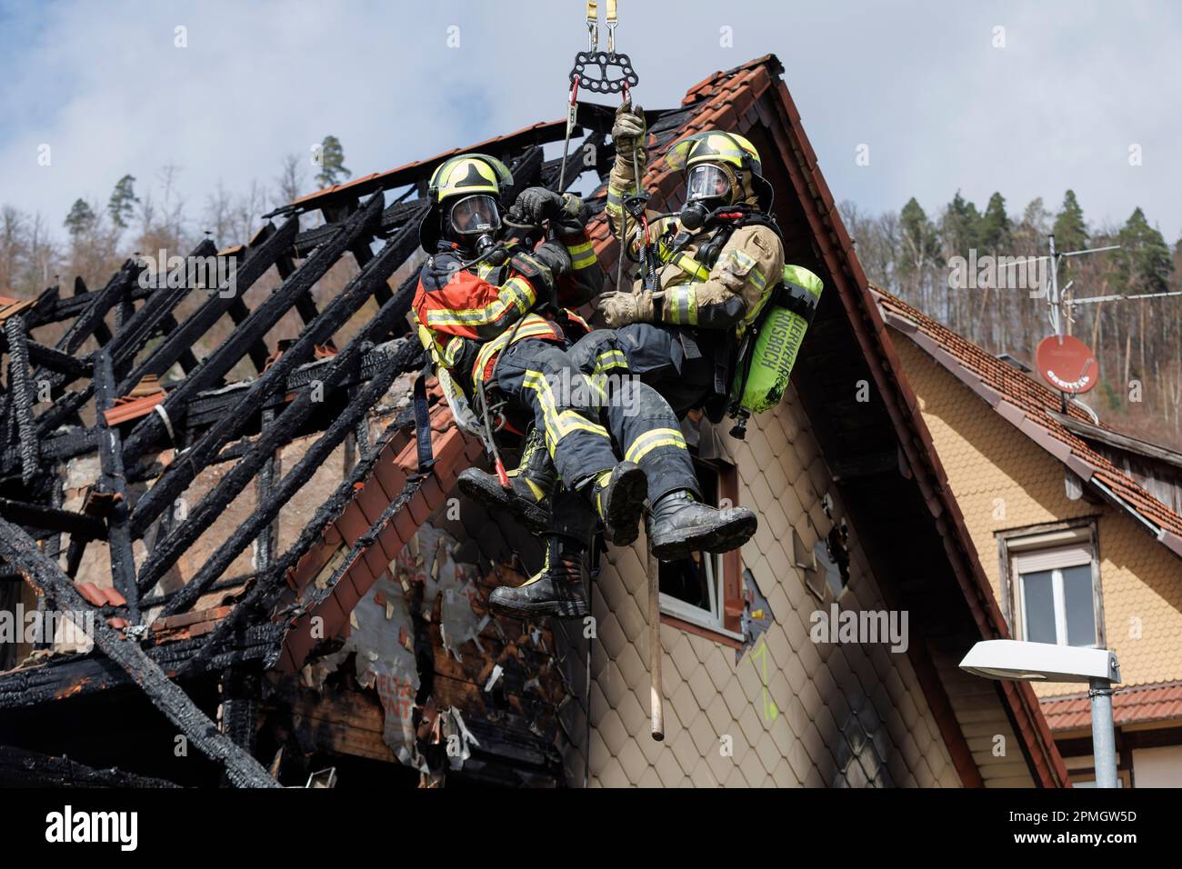 Gernsbach, Germany. 13th Apr, 2023. Two firefighters are lifted out of ...