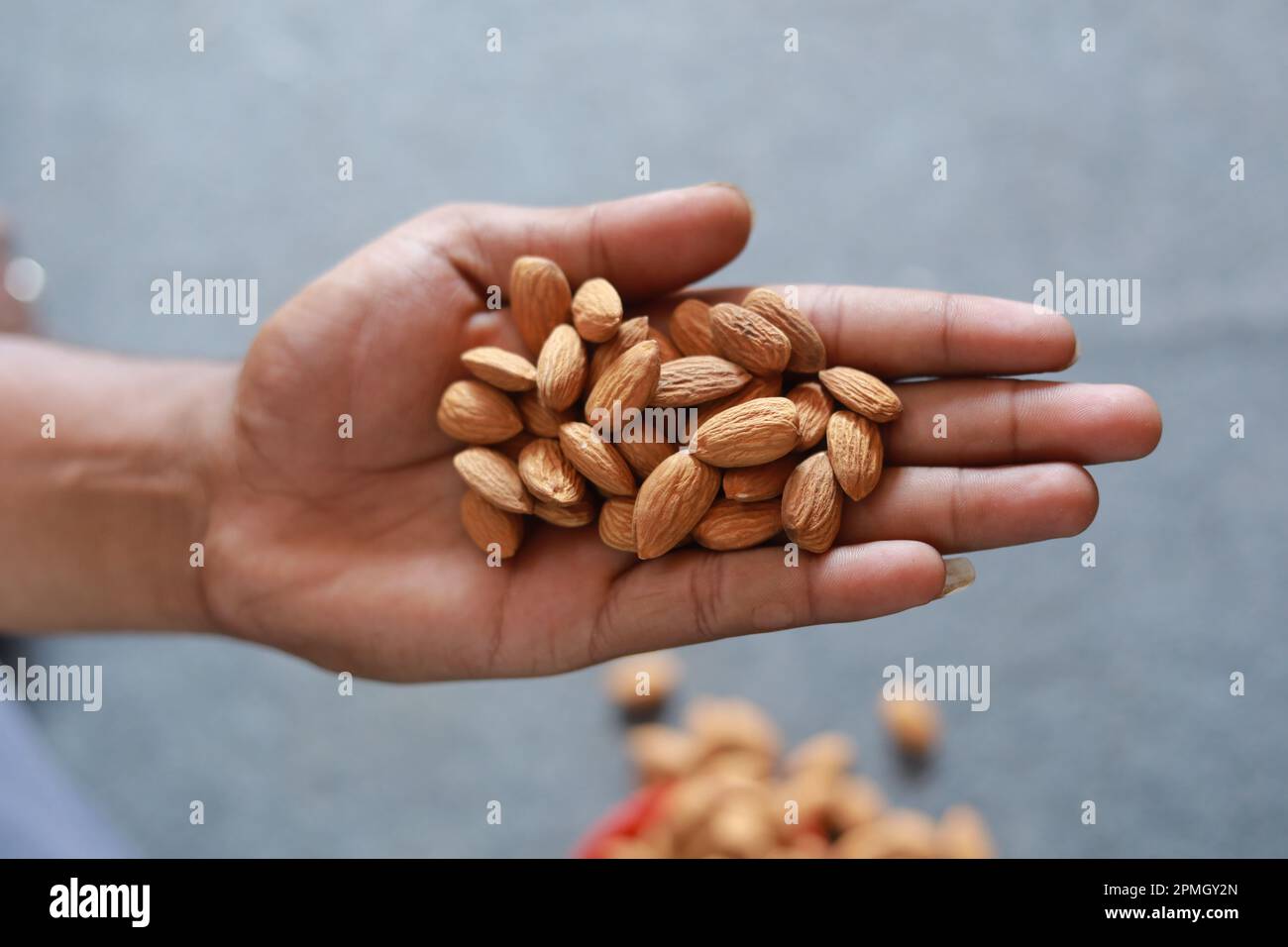almonds in white bowl and brown fabric on white background. top view ...