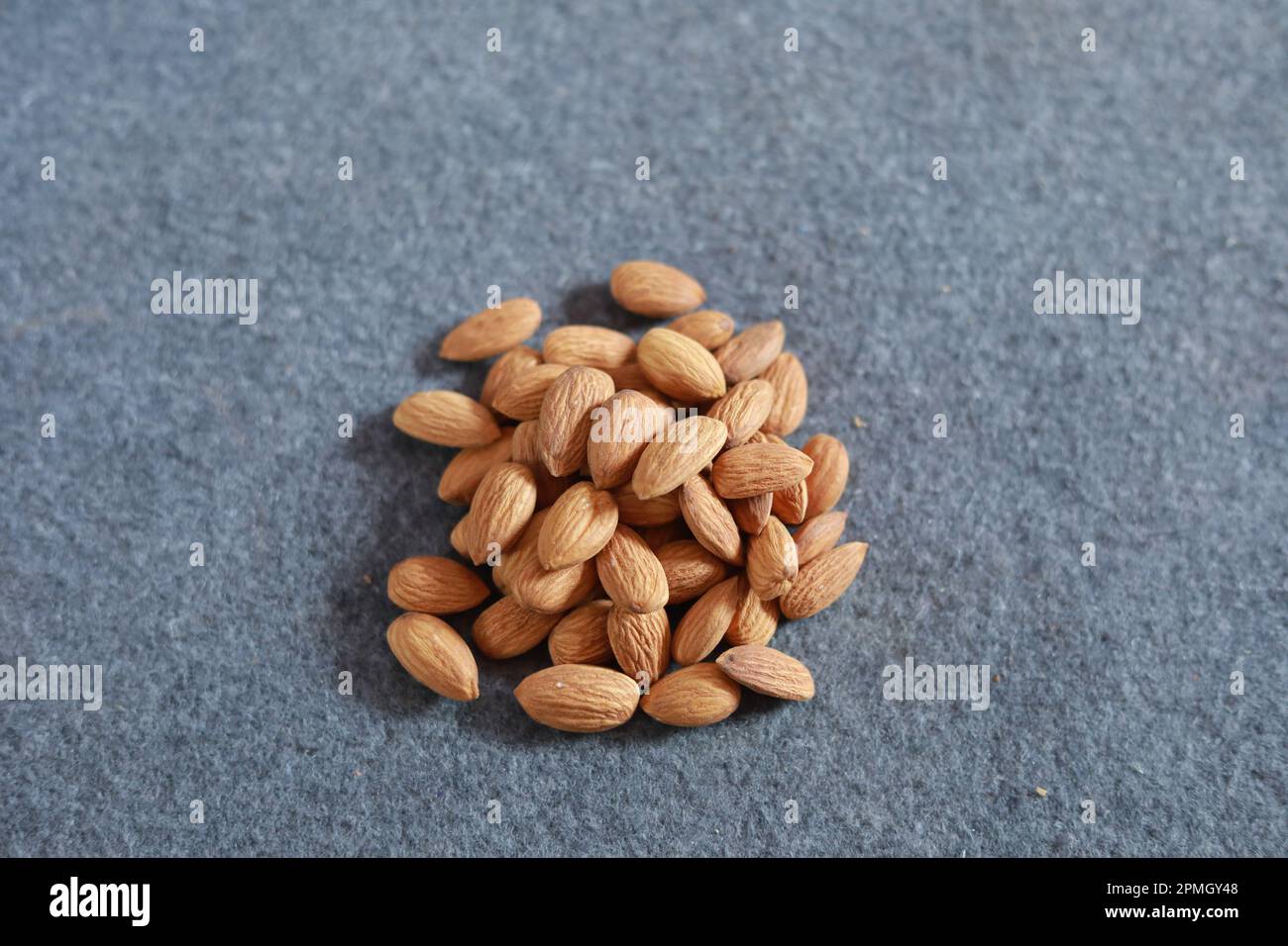 almonds in white bowl and brown fabric on white background. top view ...