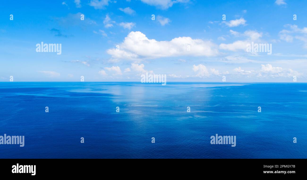 Aerial view of a blue sea surface water texture background and sun ...