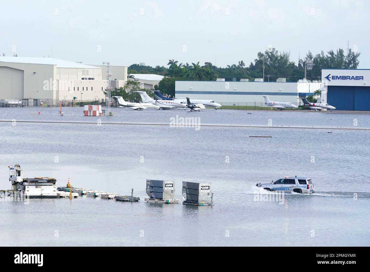 A truck drives on the flooded runway at Fort Lauderdale- Hollywood ...