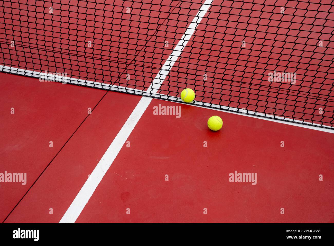 two balls near the net of a tennis court Stock Photo - Alamy