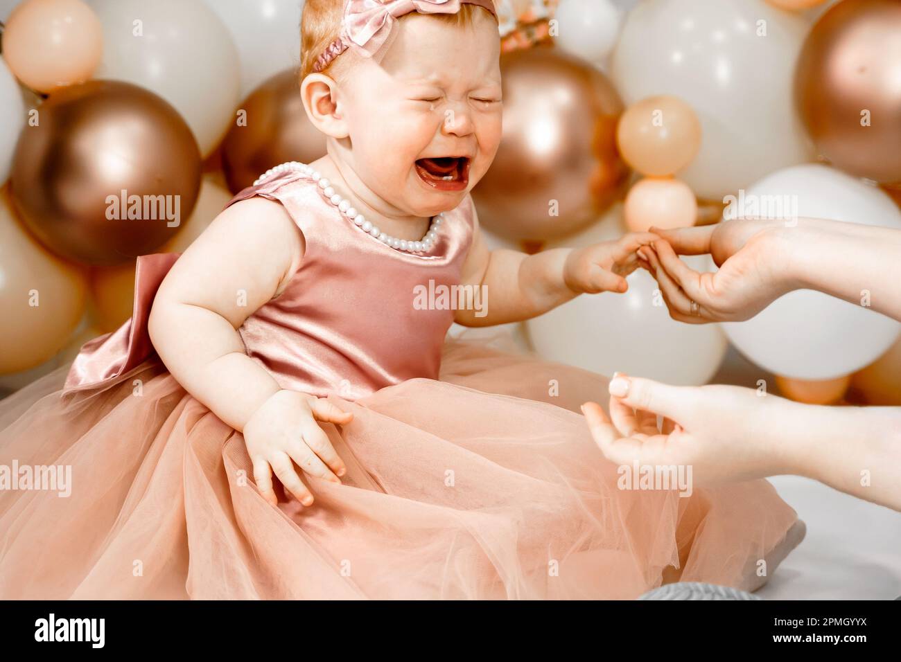 Little crying unhappy redhead baby girl celebrates first birthday ...