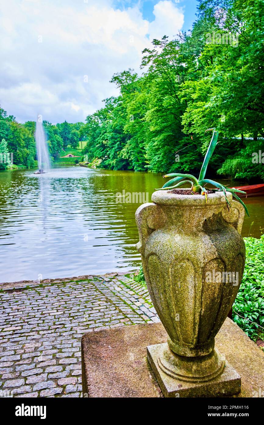 The vase with aloe plant and Ionian Sea lake with Snake fountain of ...