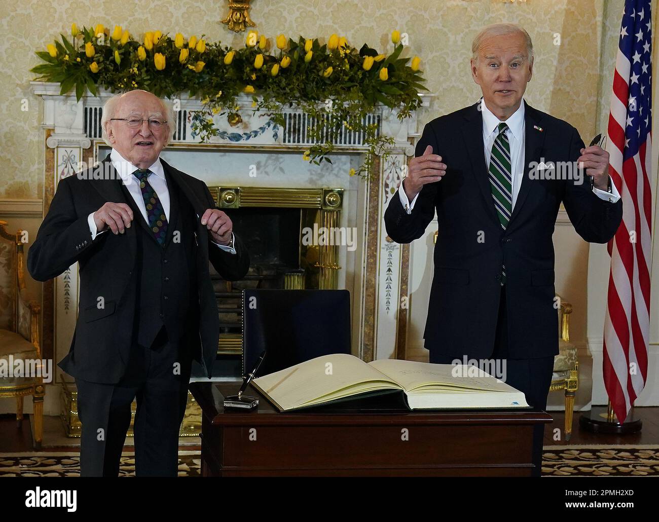 US President Joe Biden with Irish President Michael D Higgins after signing the visitors book in ...