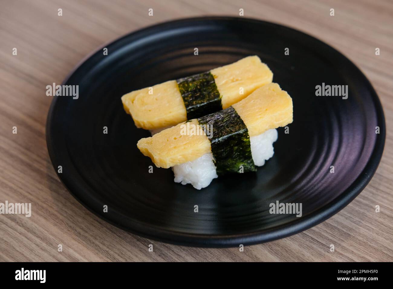 Tamago egg sushi, egg omelet on sushi rice. served on plate Stock Photo ...