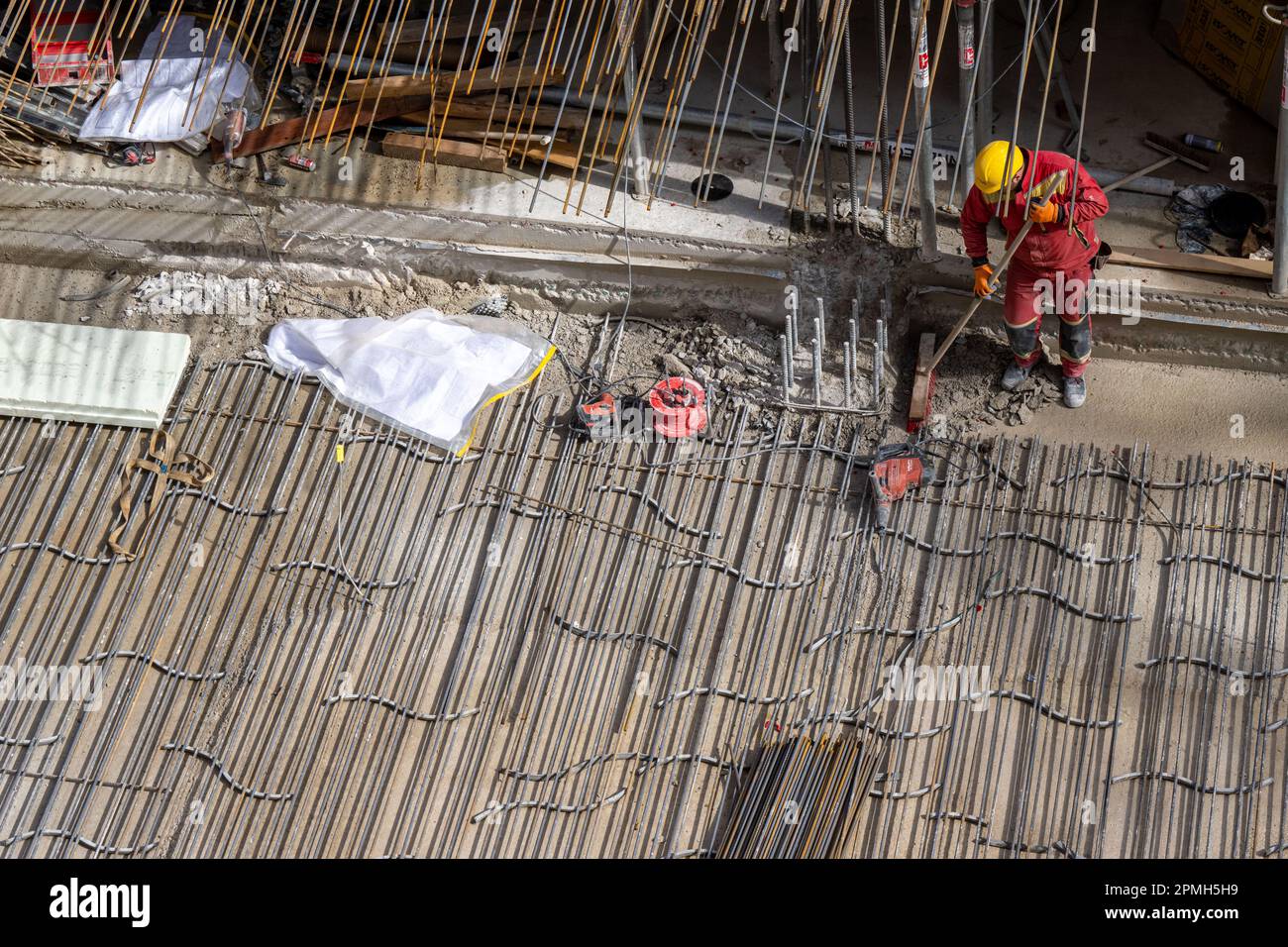 Munich, Germany. 13th Apr, 2023. A construction worker stands on a ...