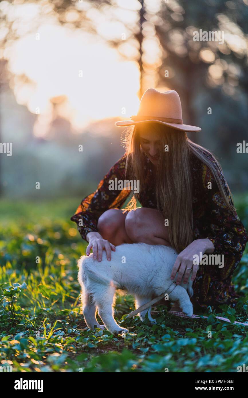 A cheerful Caucasian female enjoying a tender moment with a cuddly ...