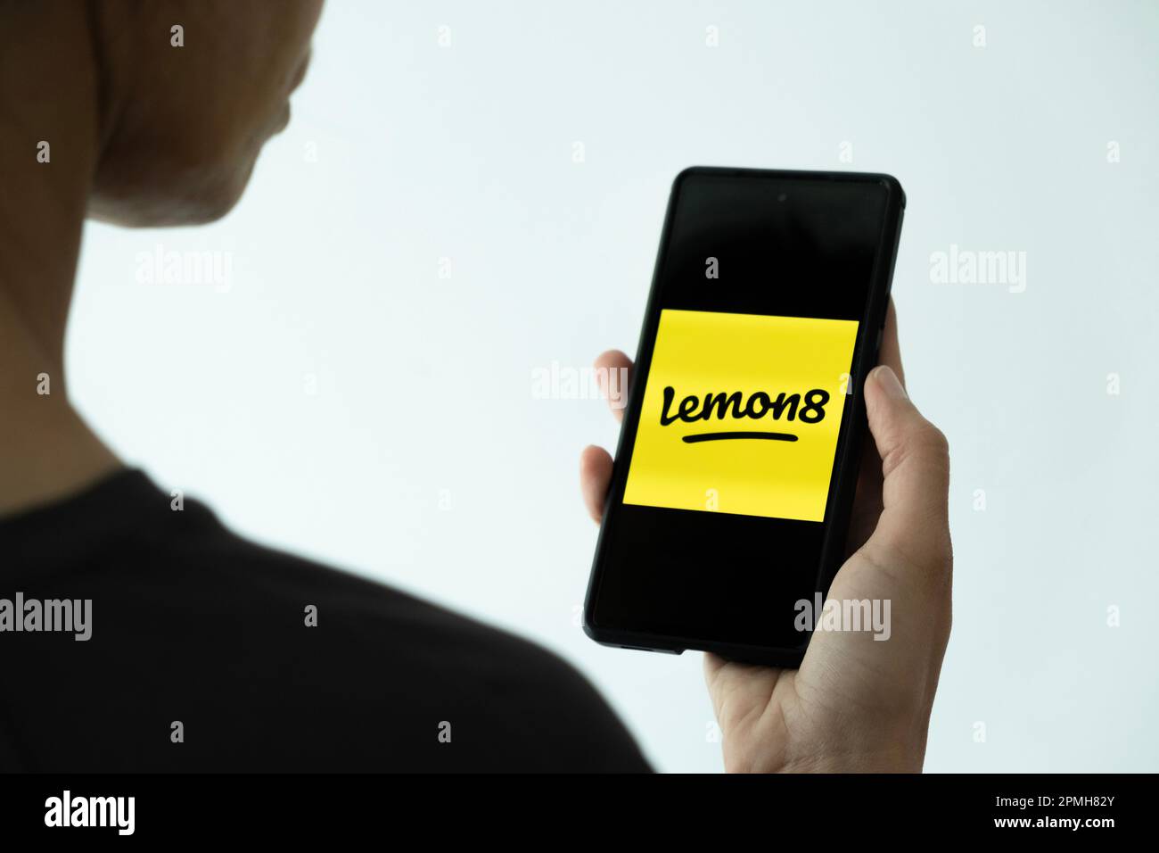 Benidorm, Spain - April 13, 2023: Woman hand holds phone with Lemon8 app. Lemon8 is photo-based ...