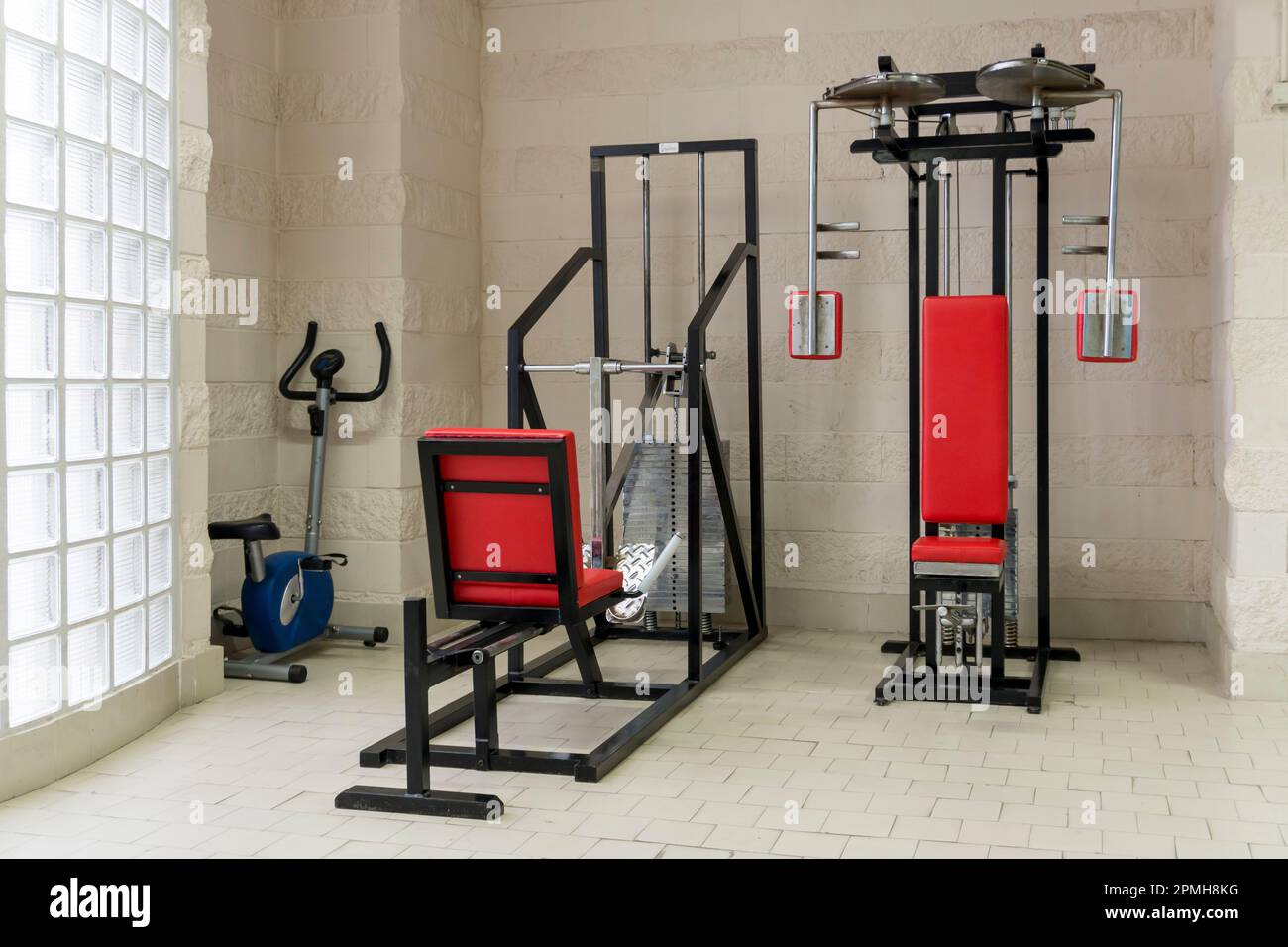 Old and worn gym machines on an empty place Stock Photo - Alamy