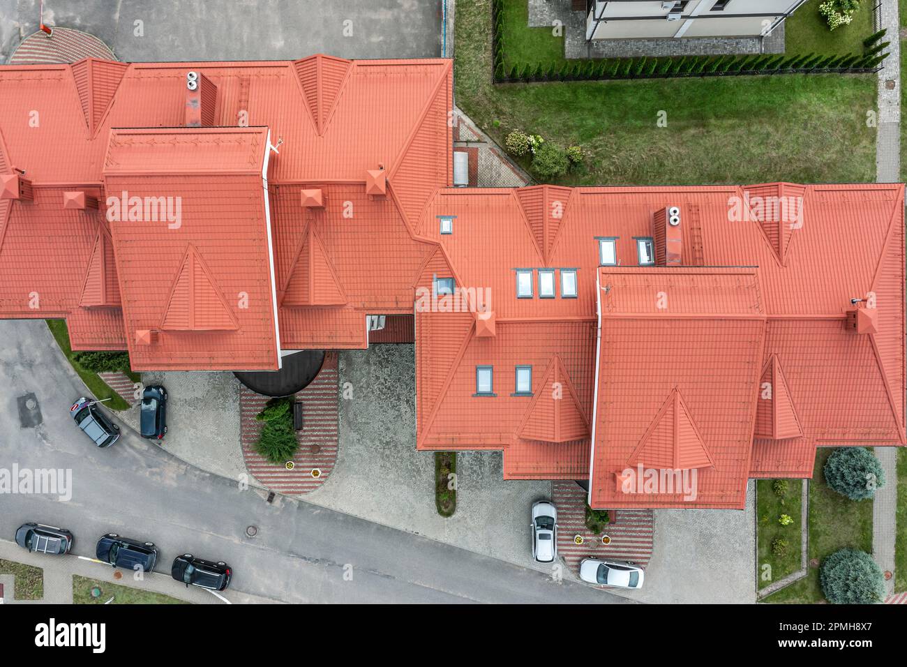 red tiled sloping rooftop of modern residential house with skylights ...