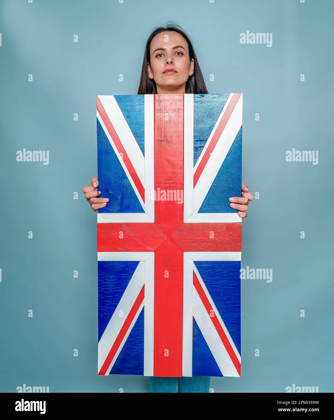 Woman holds a vertical flag of Great Britain Stock Photo - Alamy