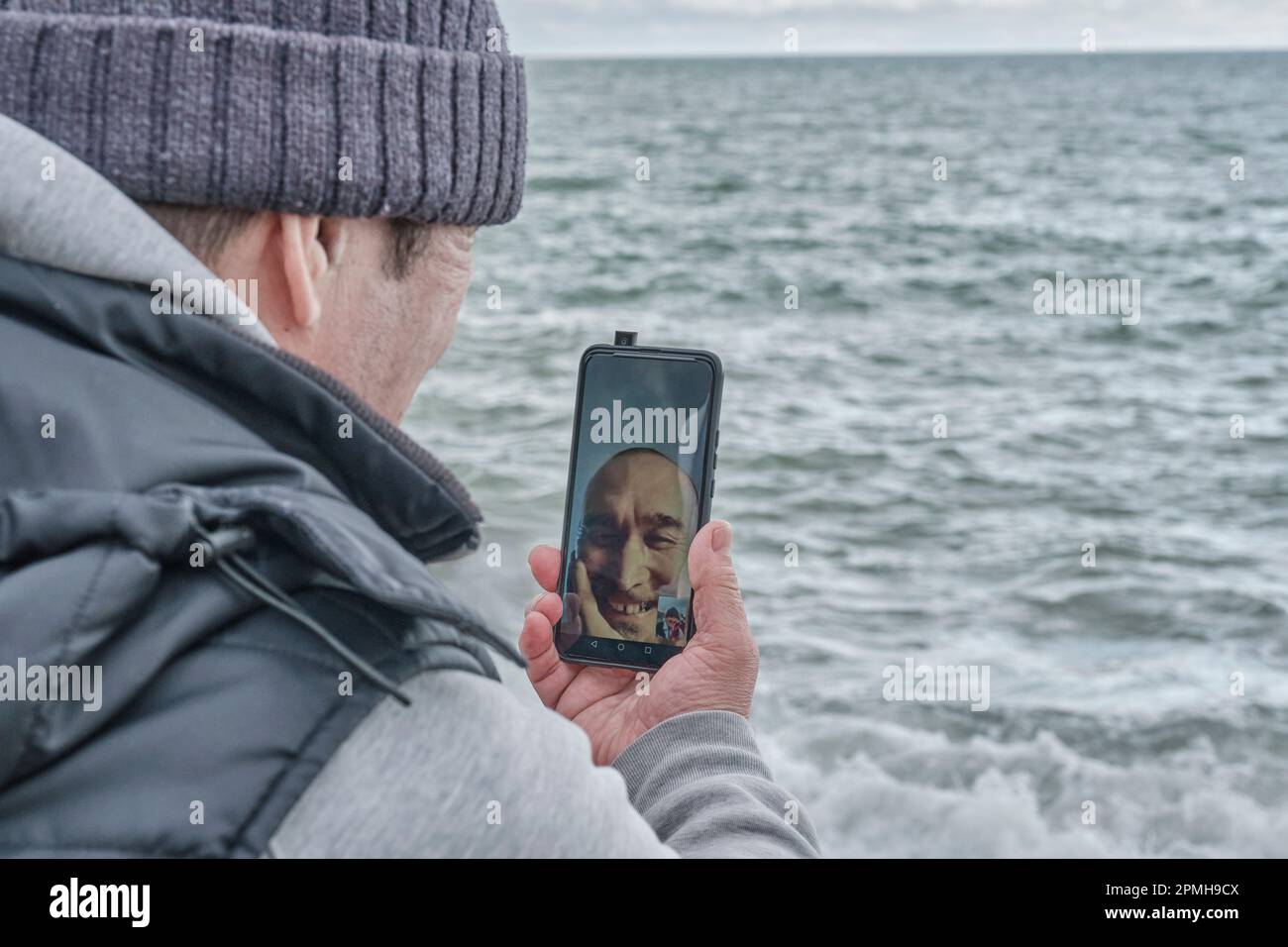 Senior man talking on video call with his friend using smartphone Stock ...