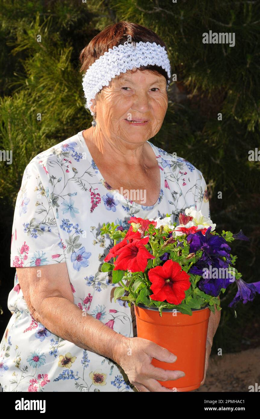 A Senior woman tending to a garden Stock Photo - Alamy