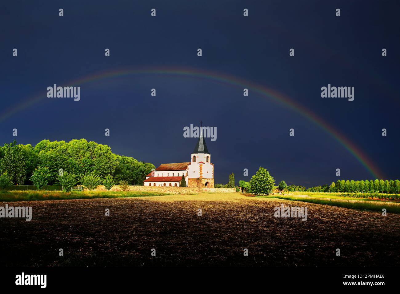 Romanesque church of Dompeter with rainbow, Alsace, France Stock Photo ...