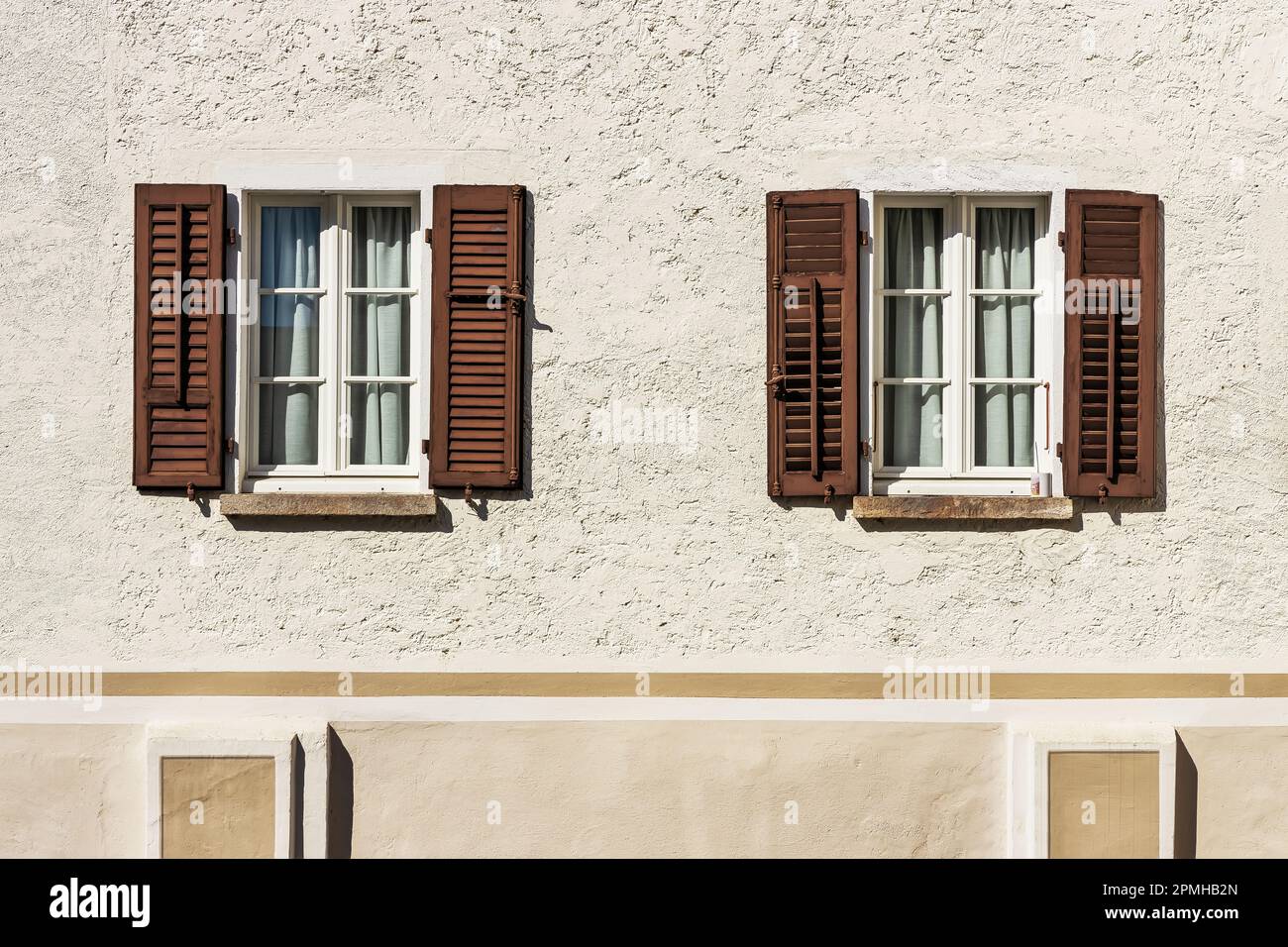Rough house wall with two windows, historic architecture background ...
