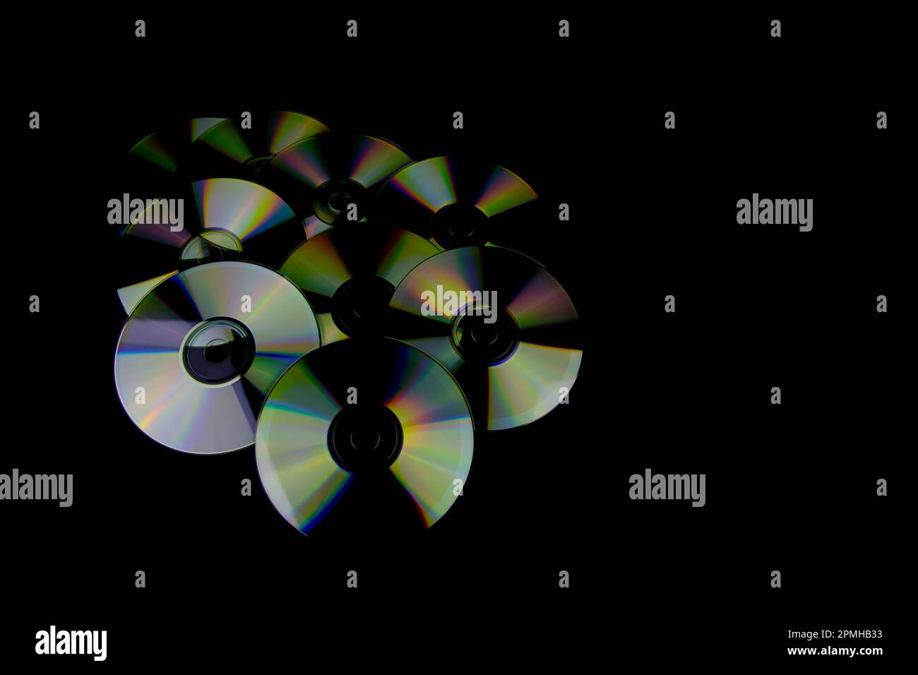 CD and DVD isolated on black background with colorful light reflections ...