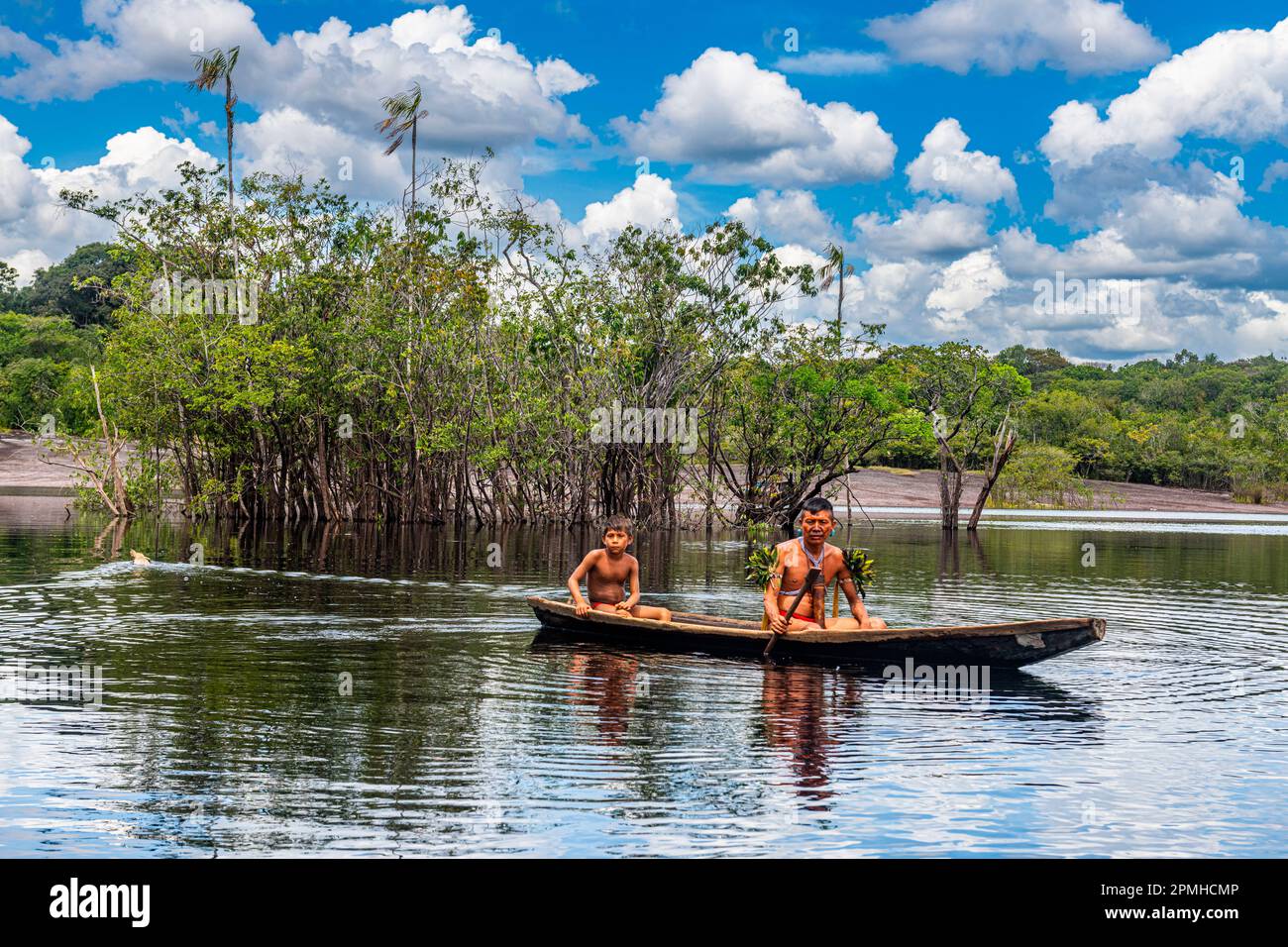 Father and son from the Yanomami tribe in a canoe, southern Venezuela ...