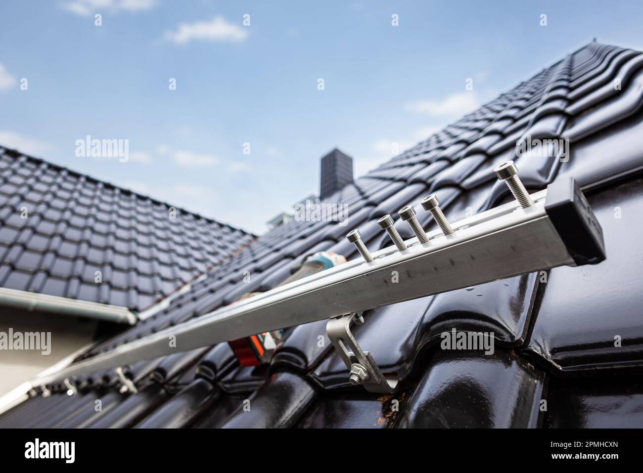 Rail for solar panel mounting system on a tiled roof Stock Photo - Alamy