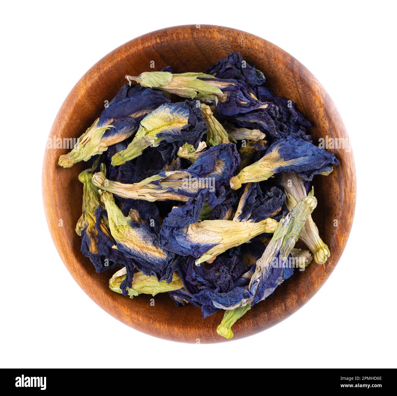 Butterfly pea flowers in wooden bowl, isolated on white background ...