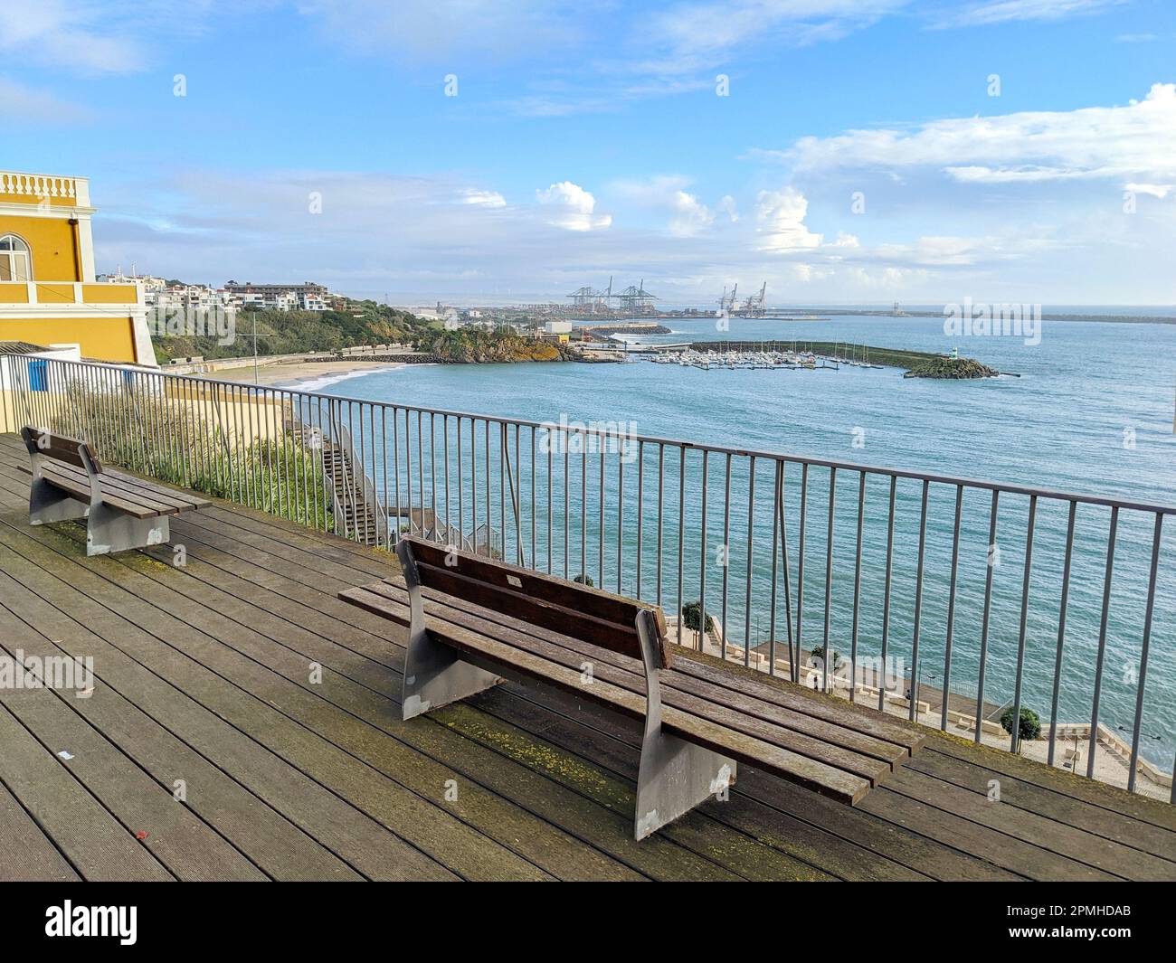 Empty bench with skyline view over town, ocean beach and cargo terminal ...